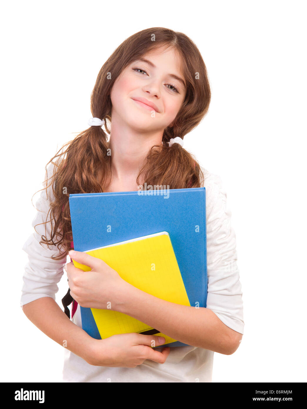 Portrait of nice happy schoolgirl with books in hands isolated on white ...
