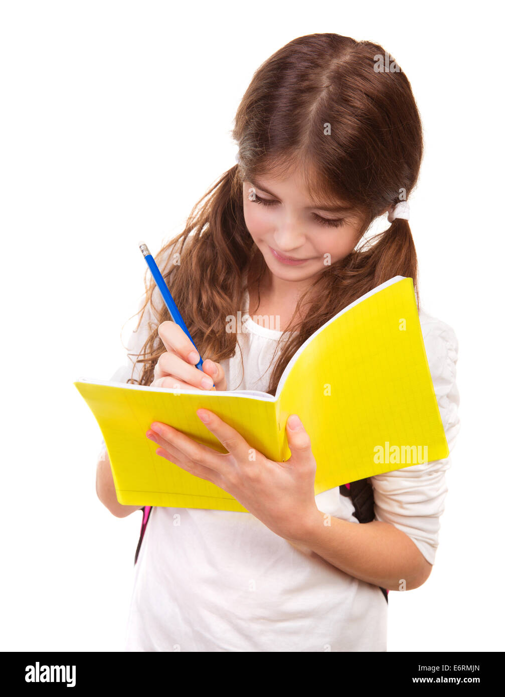 School girl writing in notebook isolated on white background, passing ...