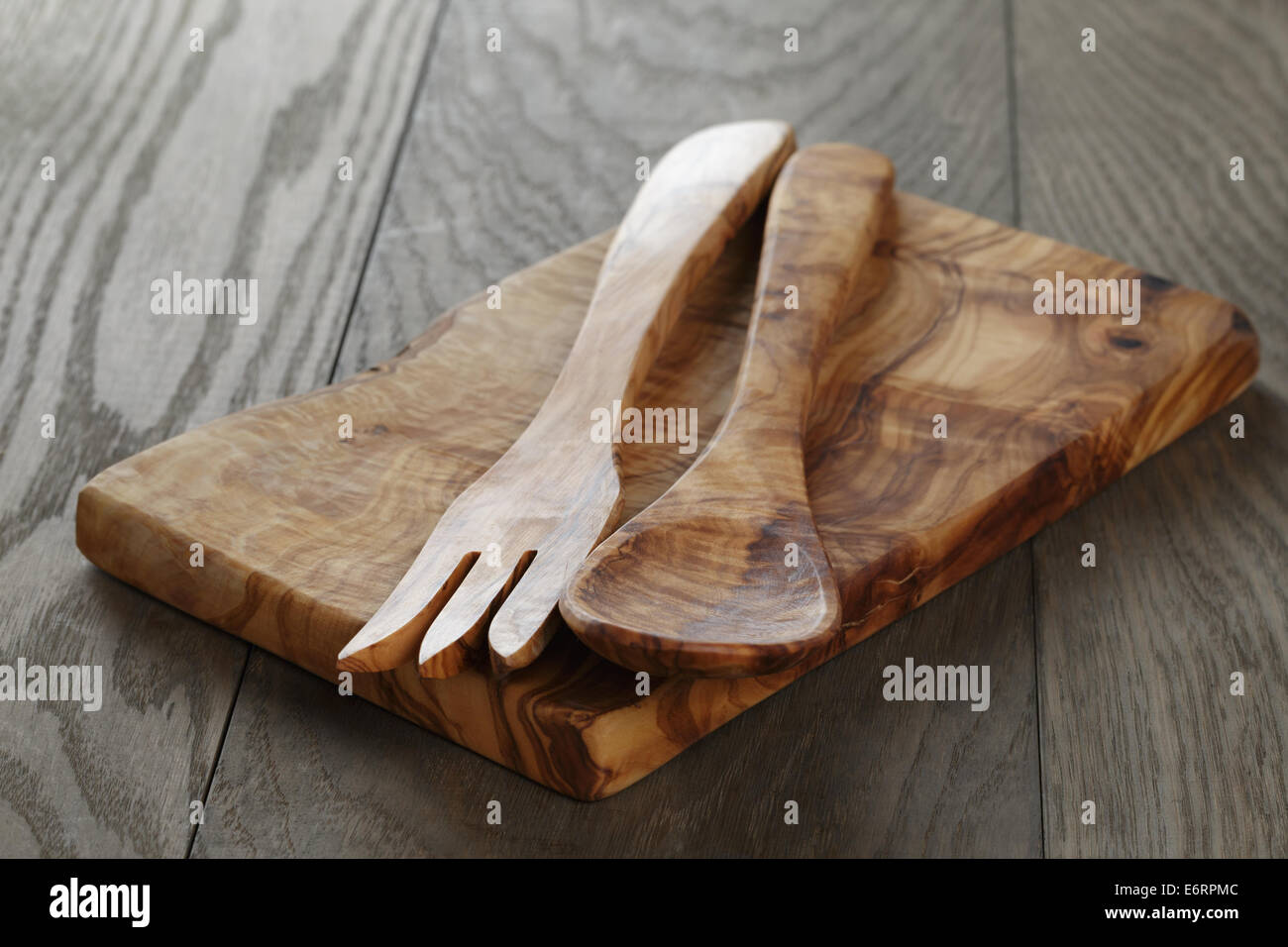 composition with olive kitchen utensils on top of oak table, rustic ...