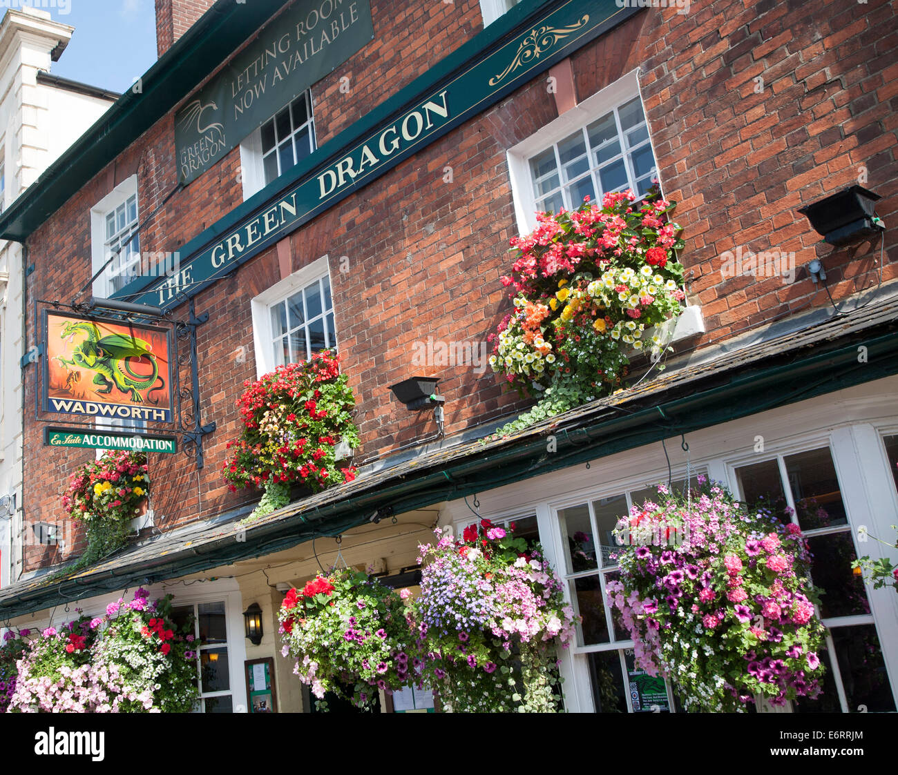 Exterior sign and floral display outside the Green Dragon pub in ...