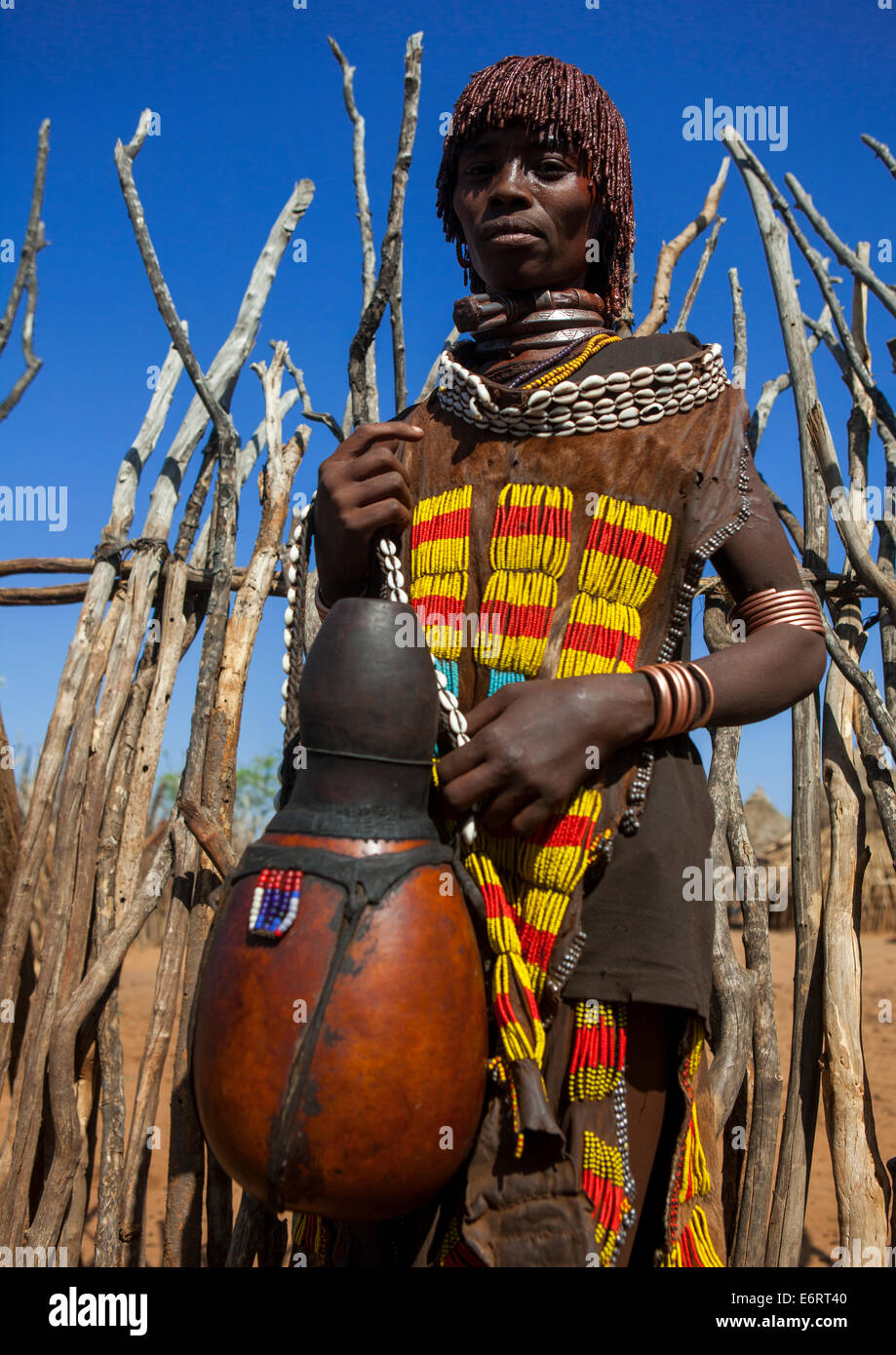 Girl Of The Hamer Tribe, In Traditional Outfit Holding A Calabash ...