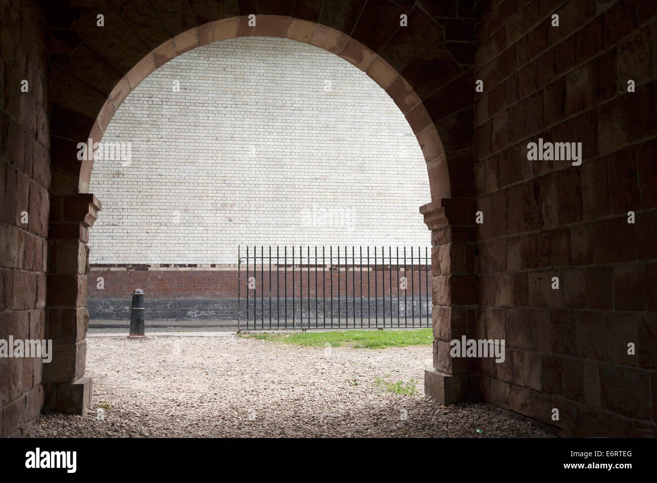 White Urban Wall through Stone Arch Stock Photo - Alamy