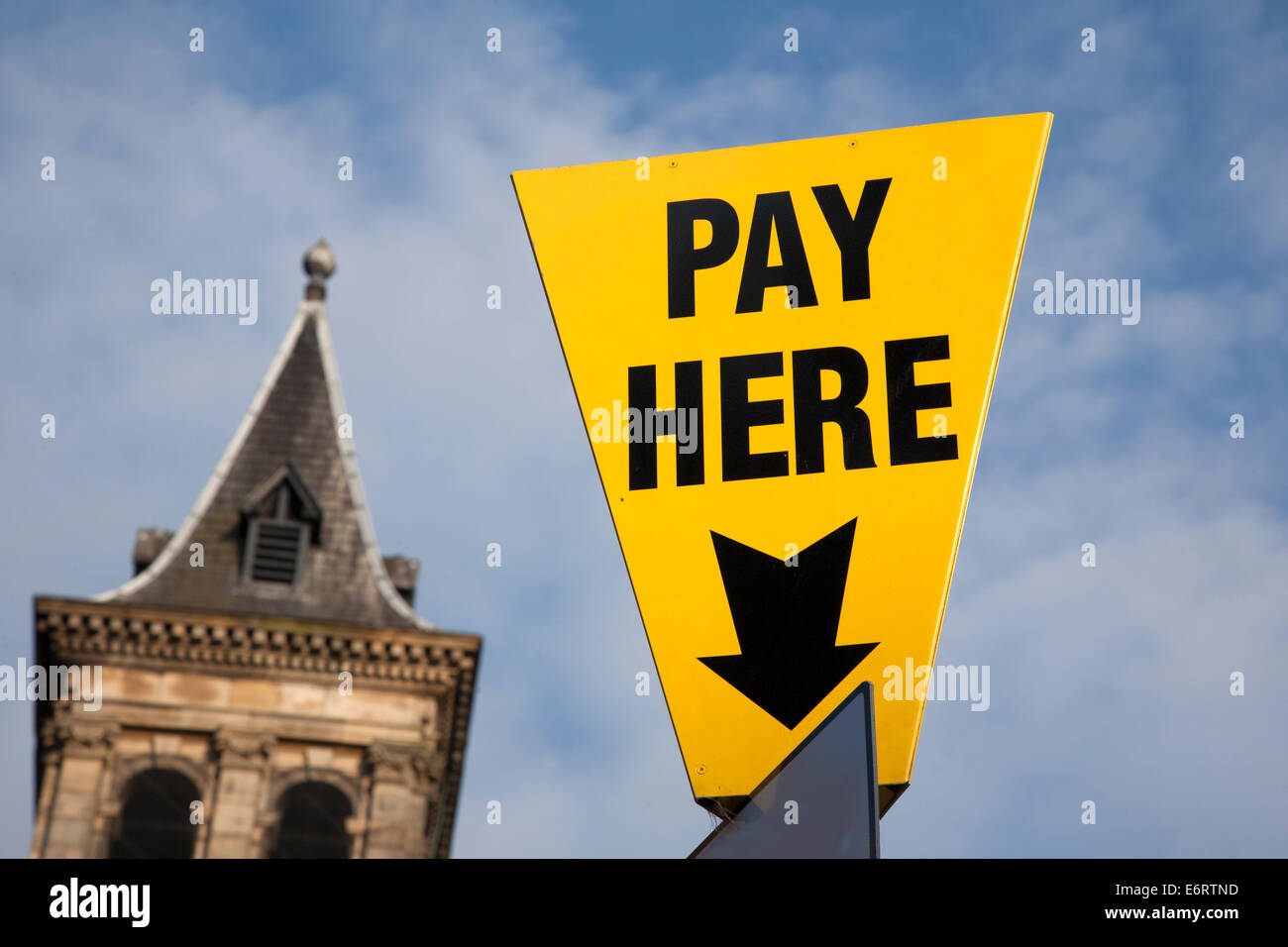 Yellow Pay Here Sign in Car Park Stock Photo - Alamy