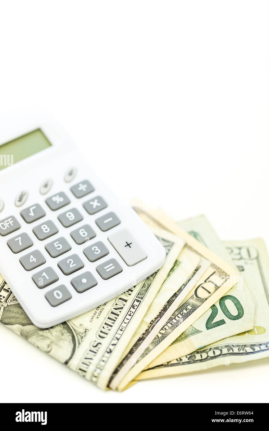 Folded US Dollars with calculator on a white background Stock Photo - Alamy