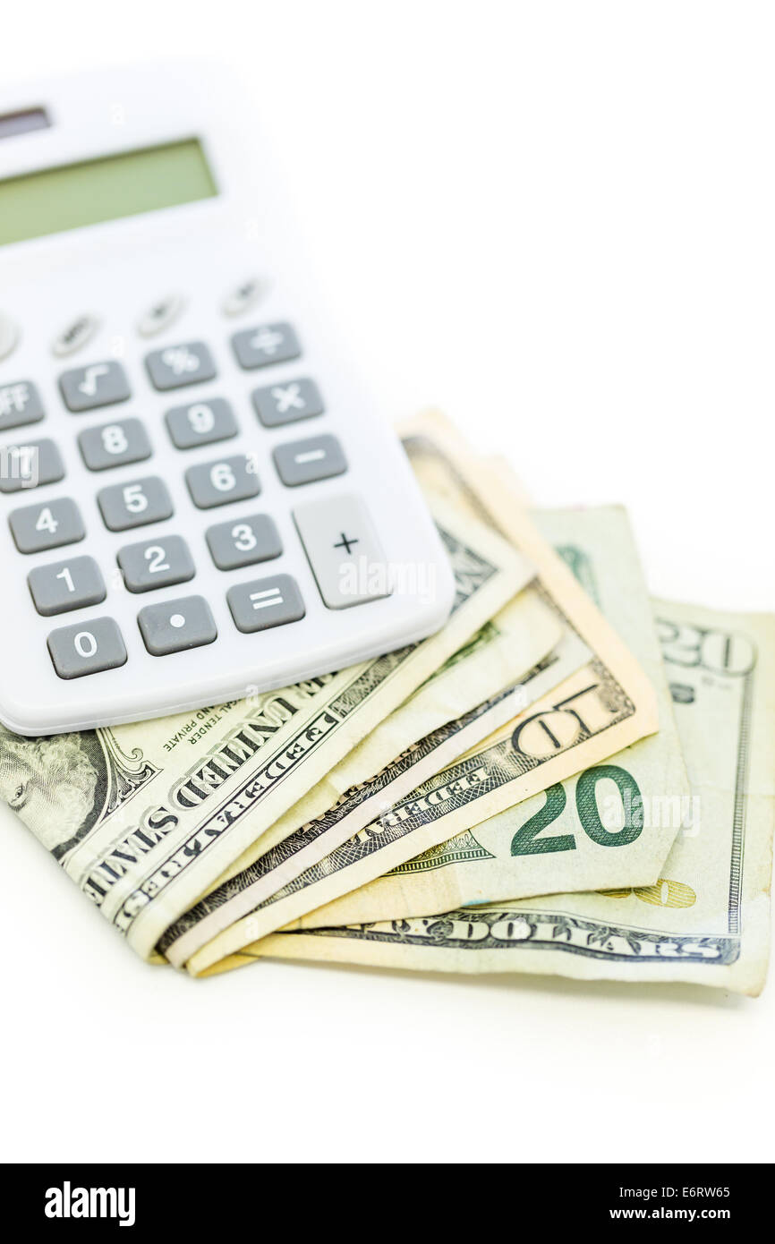 Folded US Dollars with calculator on a white background Stock Photo - Alamy