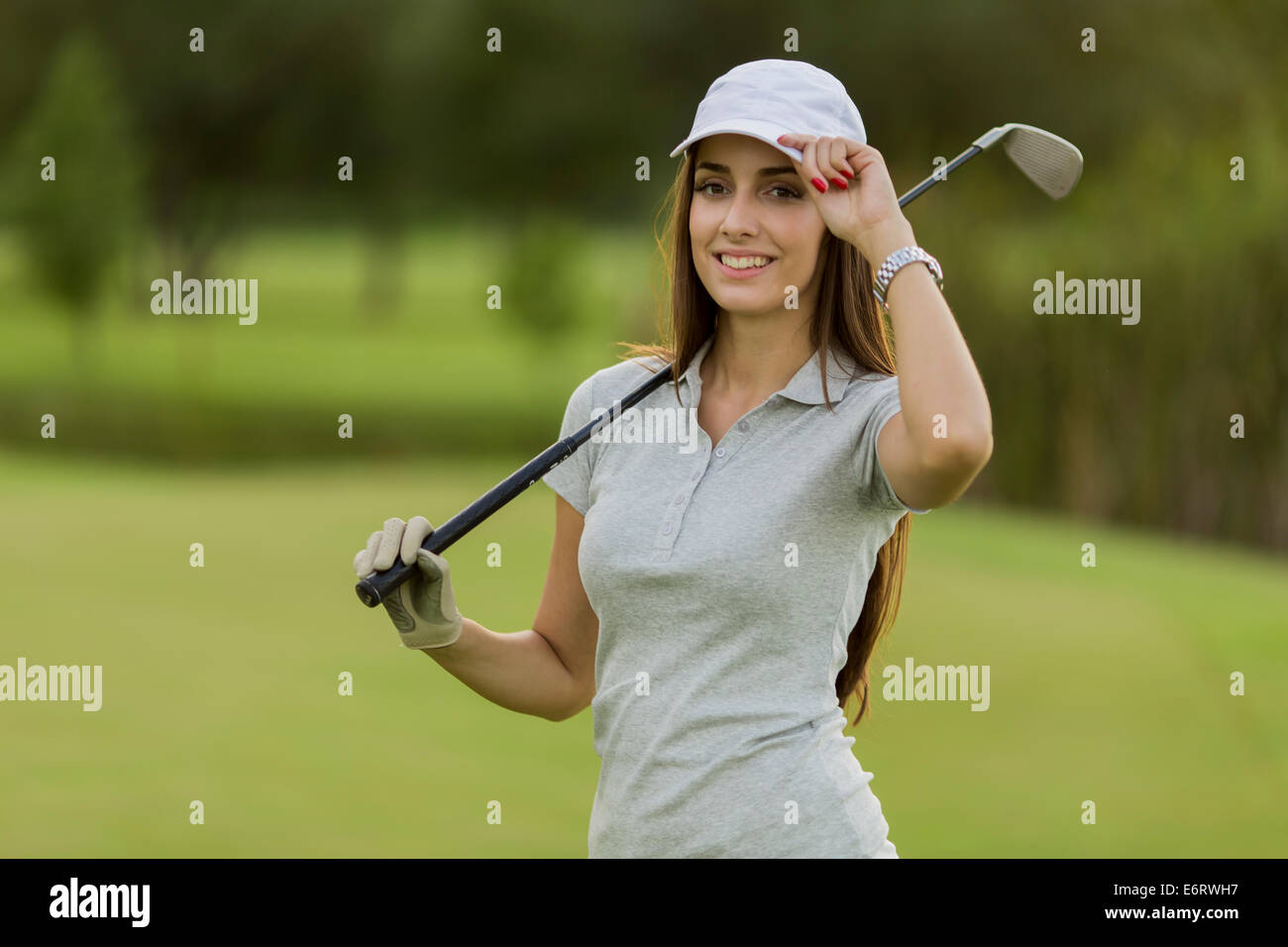 Young woman playing golf Stock Photo - Alamy
