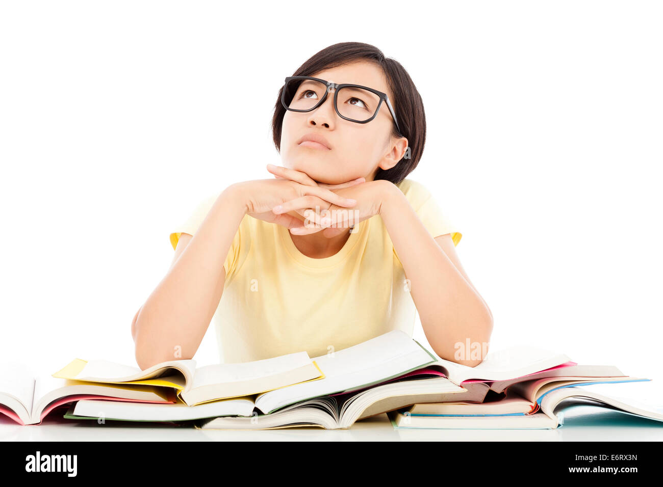 pretty young student girl thinking with book over white background ...