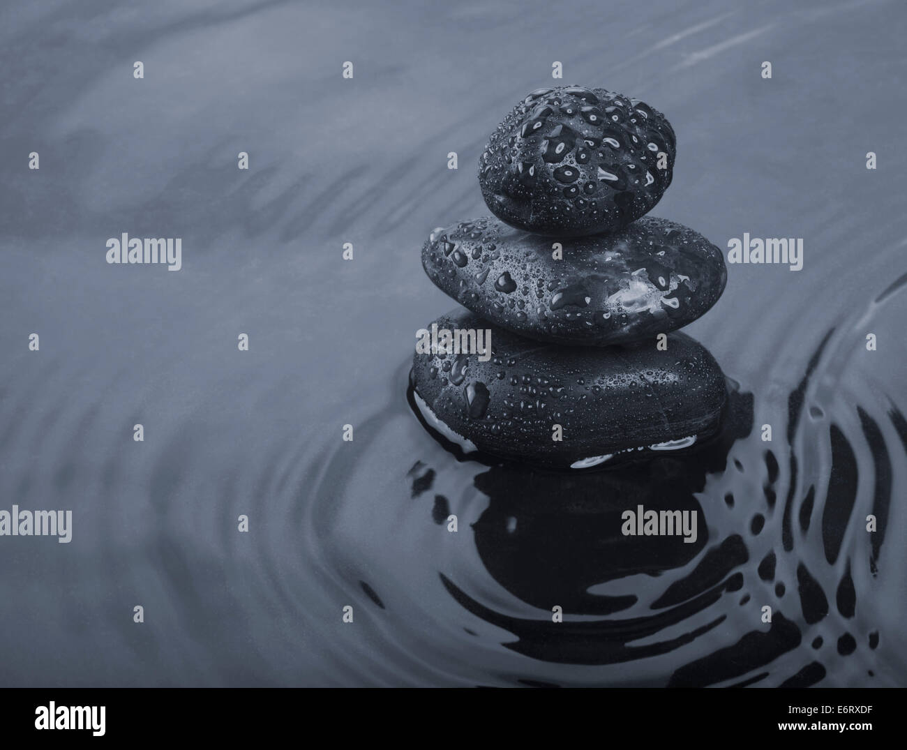 Background of a spa with black stones and dark water. Tinted image ...