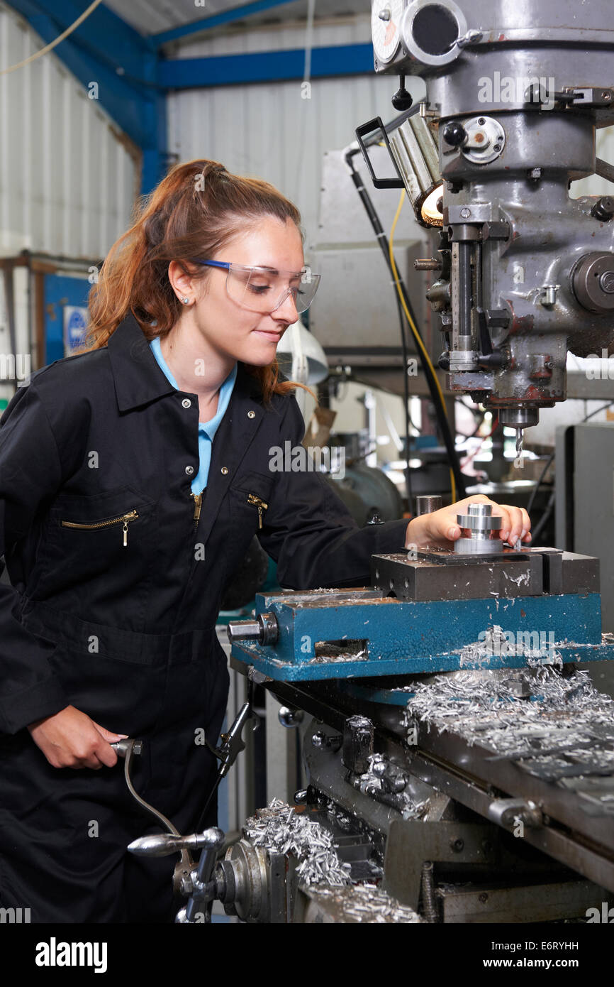 Female Apprentice Engineer Working On Drill In Factory Stock Photo - Alamy
