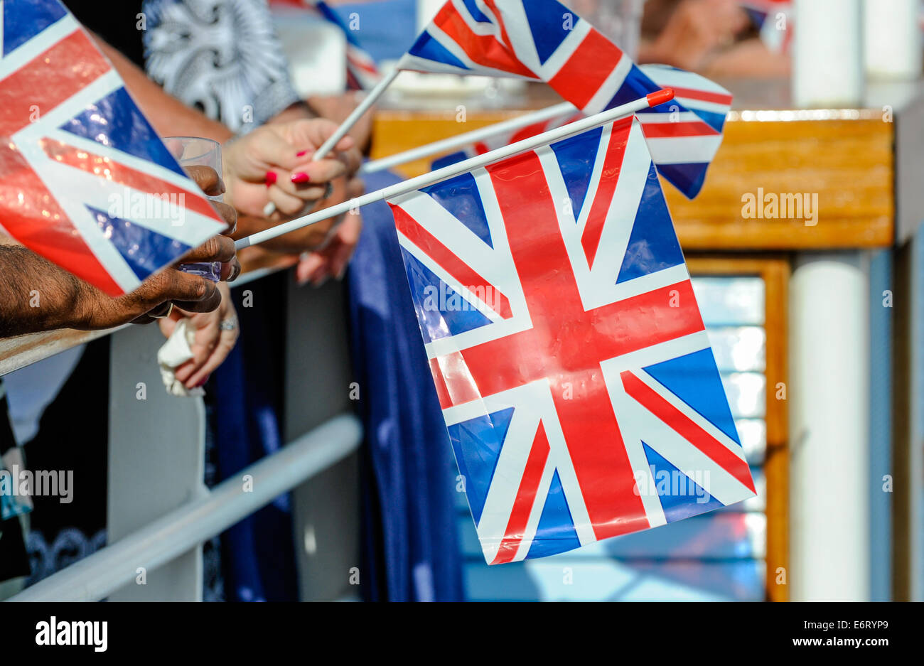 Hand held Union Jack flag at celebrations on a cruise ship Stock Photo ...