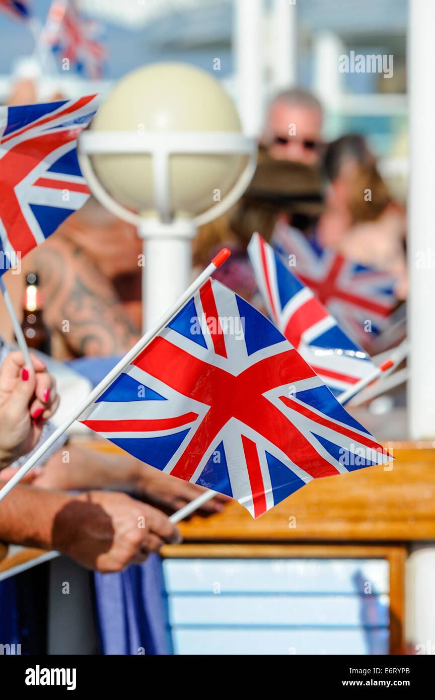 Hand held Union Jack flag at celebrations on a cruise ship Stock Photo ...