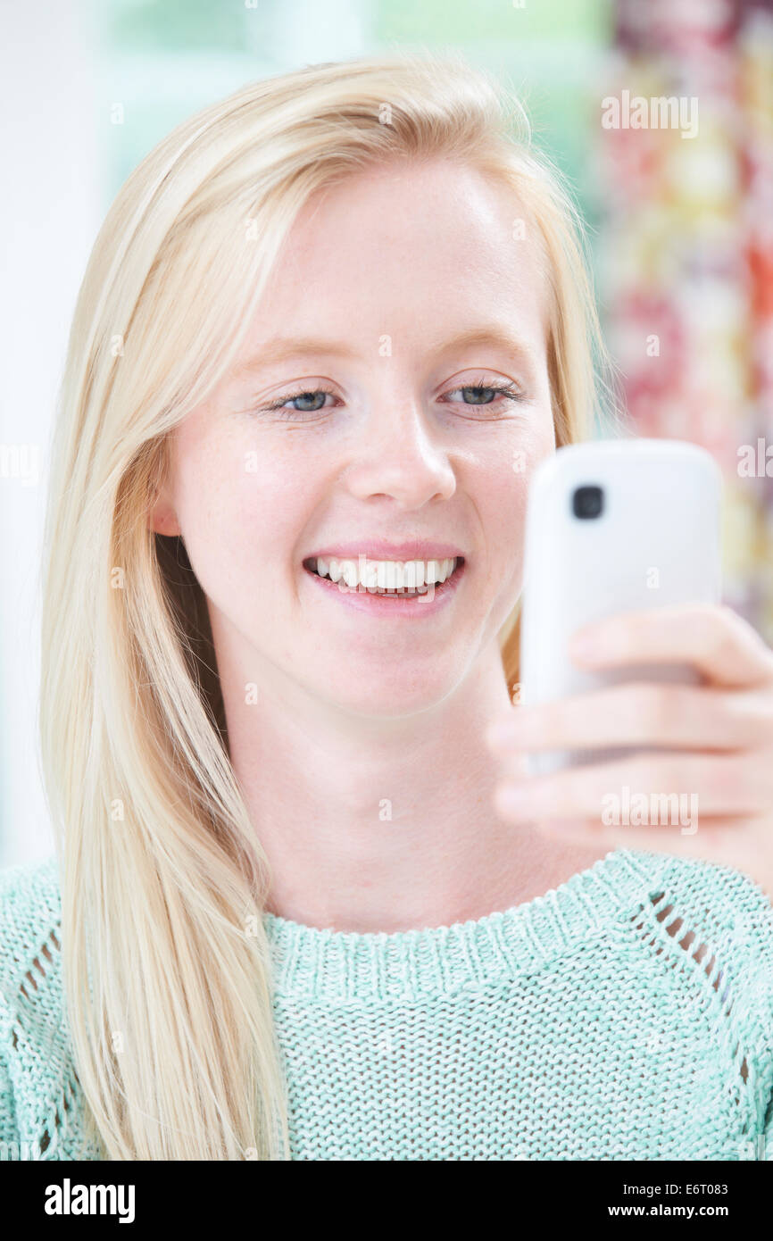 Smiling Young Woman Reading Text Message Stock Photo - Alamy