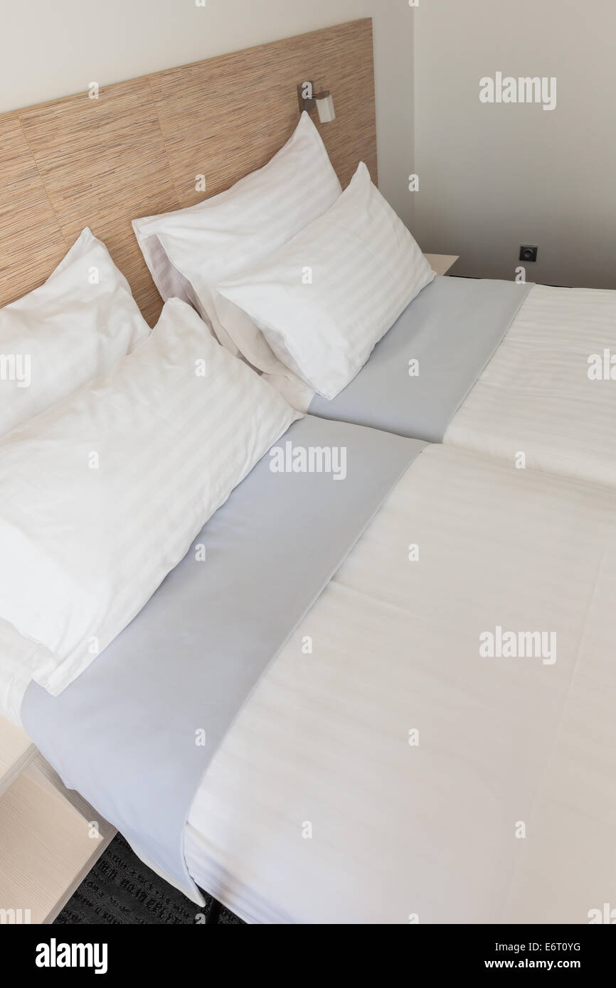 Prepared fresh bed, scene in hotel room. Vertical shot Stock Photo - Alamy