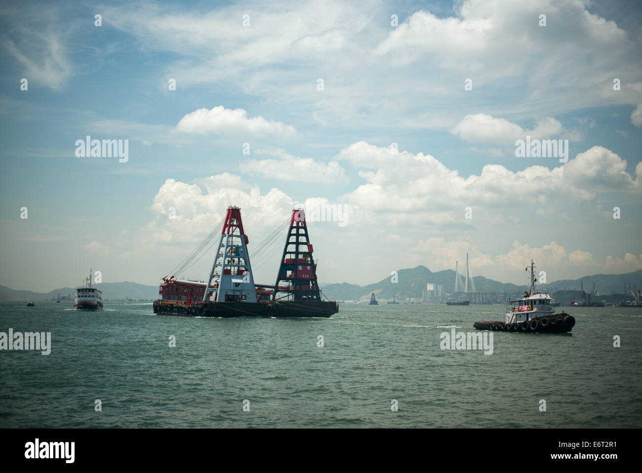 A tug boat towing some construction materials in Victoria harbour Stock ...