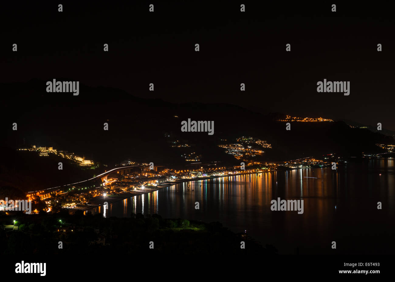 View of sicilian coast form Taormina town at night Stock Photo - Alamy