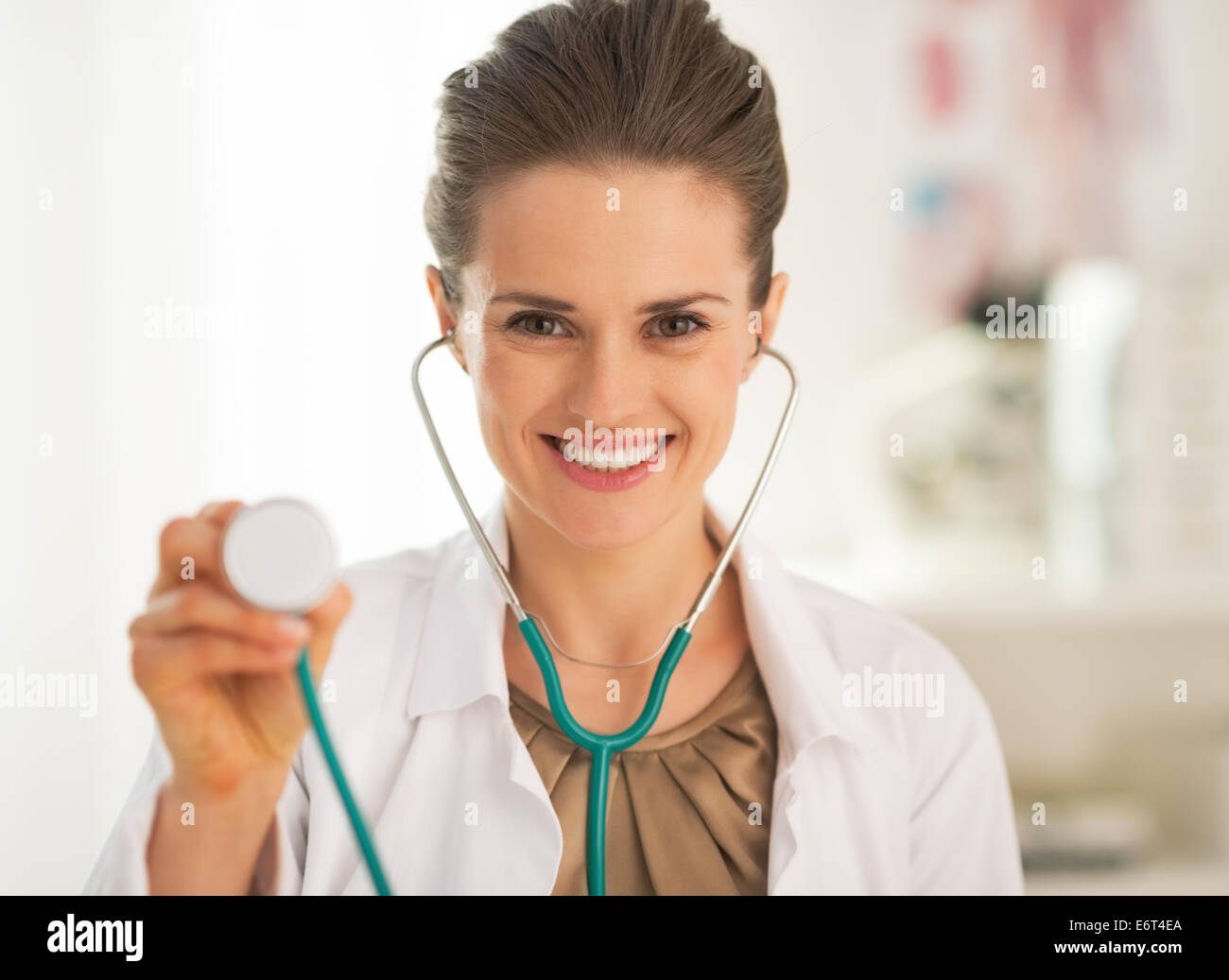 Smiling doctor woman using stethoscope Stock Photo - Alamy