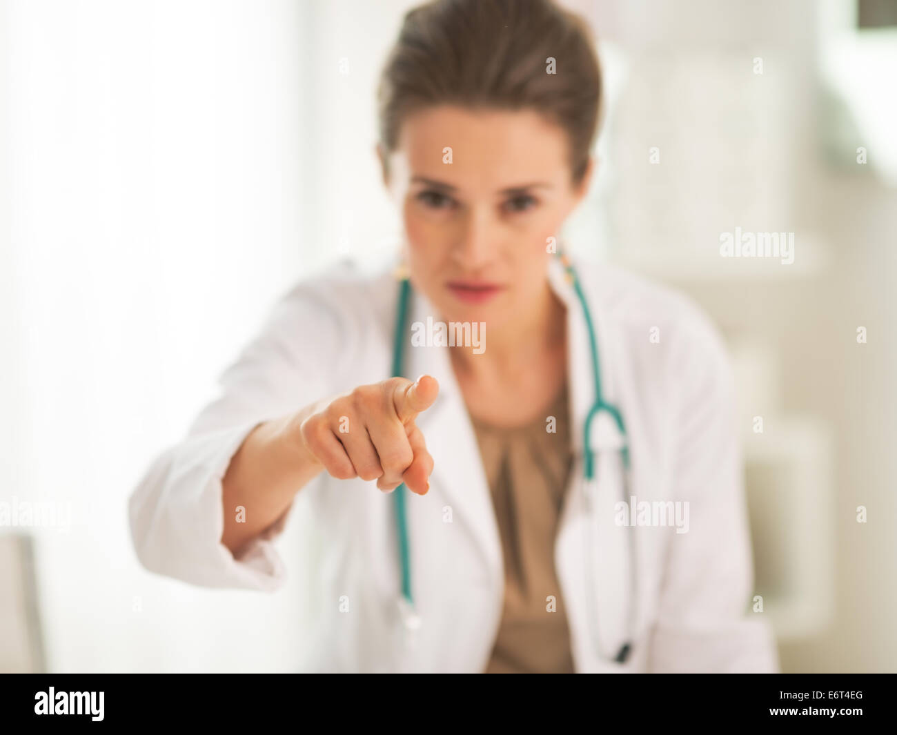 Closeup on doctor woman pointing in camera Stock Photo - Alamy