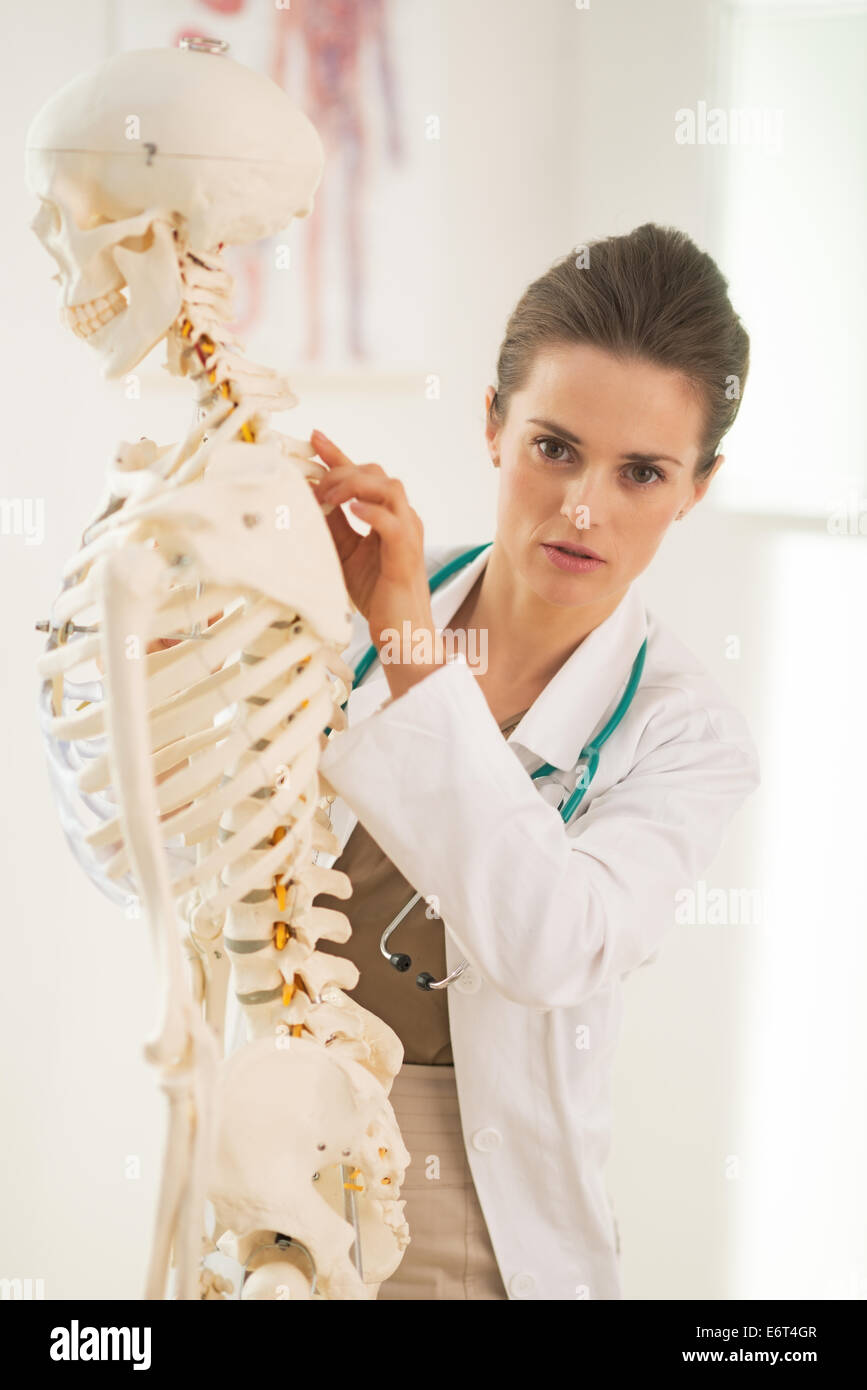 Doctor woman pointing on human skeleton anatomical model Stock Photo ...