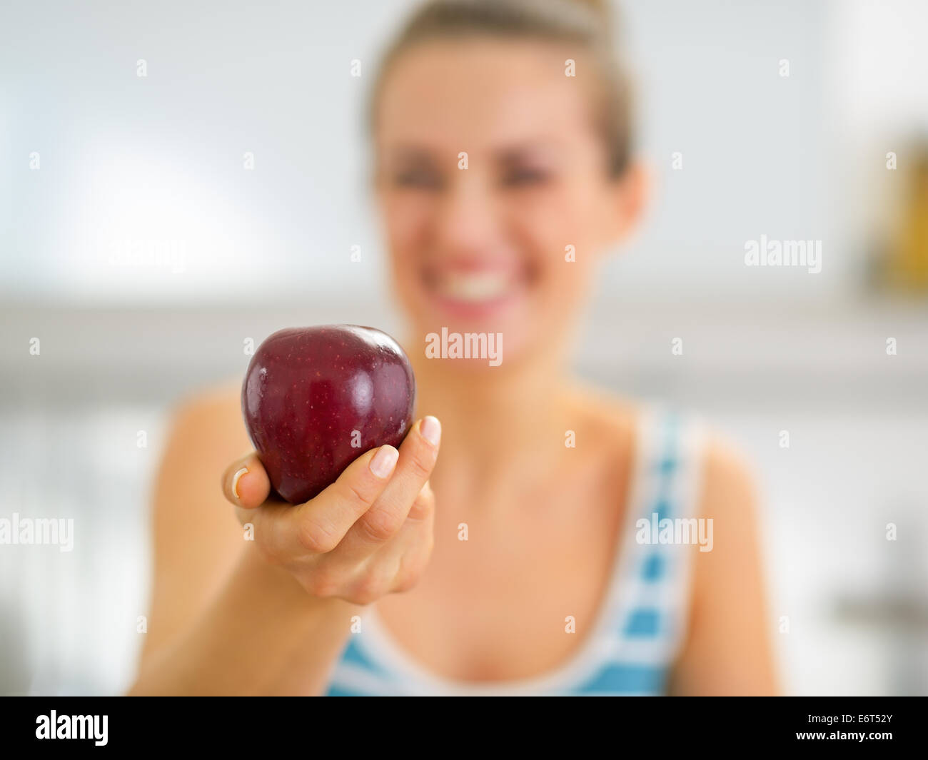 Closeup on young woman giving apple Stock Photo - Alamy