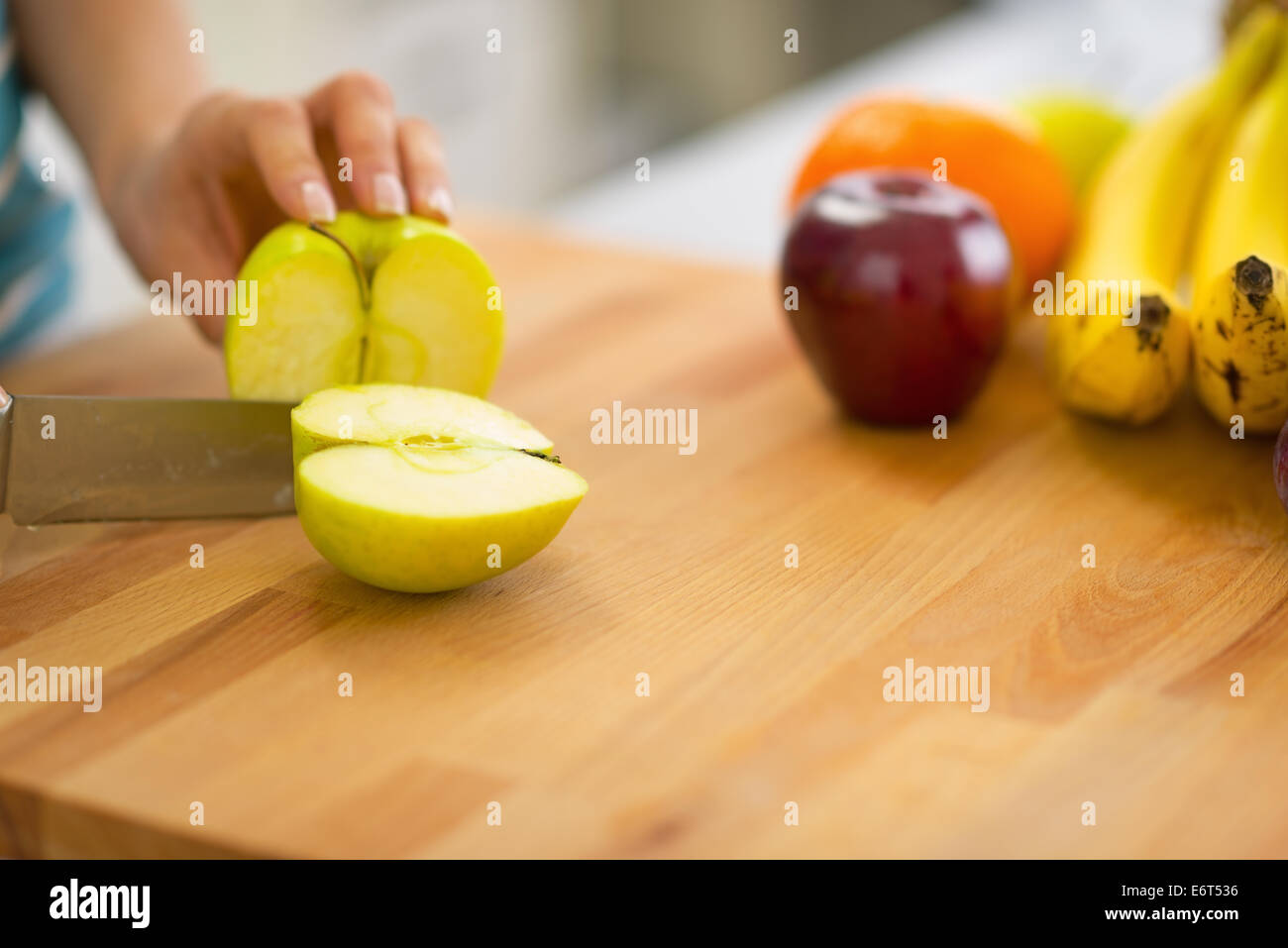 Closeup on young woman cutting apple Stock Photo - Alamy