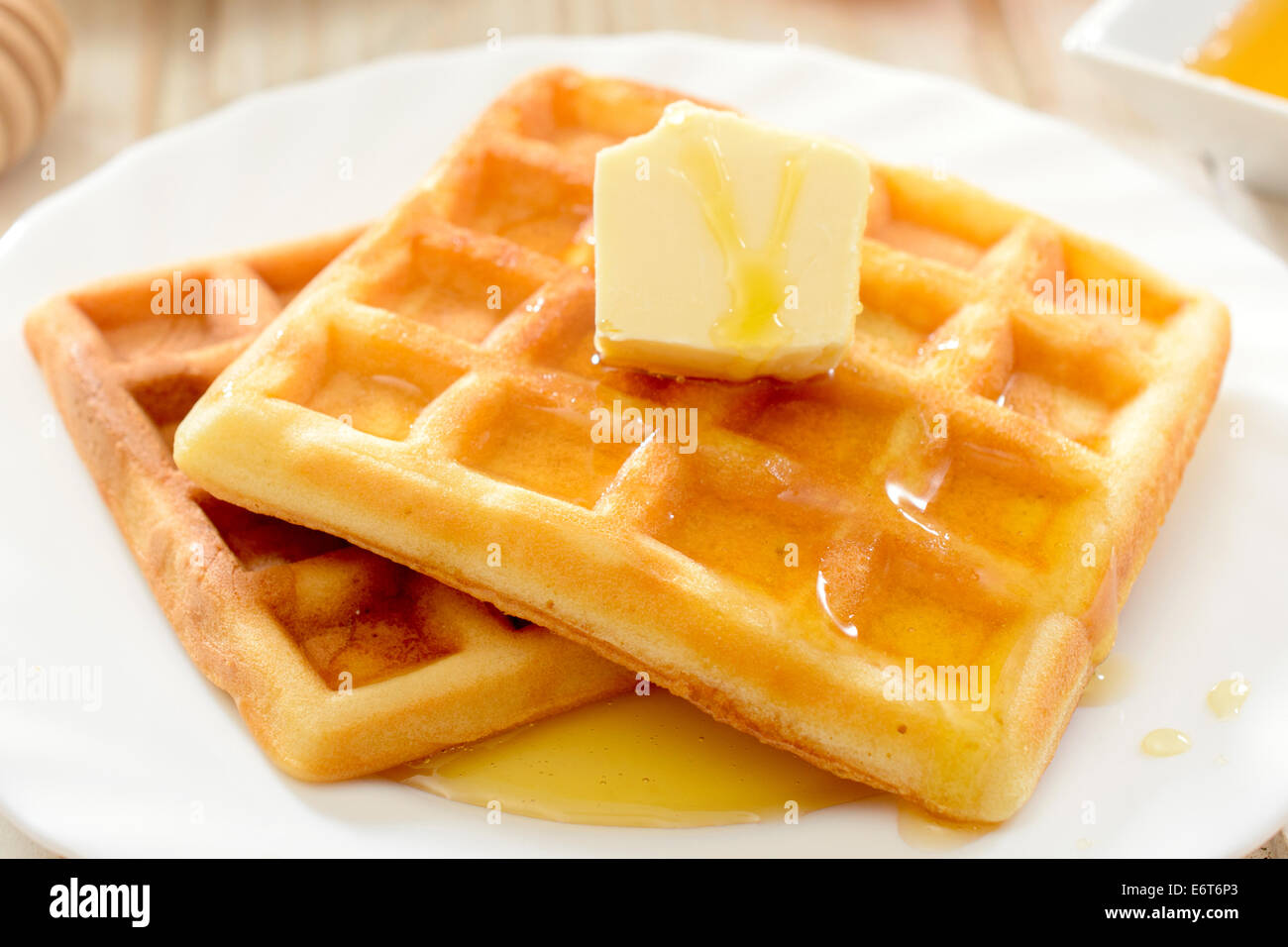 Traditional Belgian waffles with honey and butter Stock Photo - Alamy