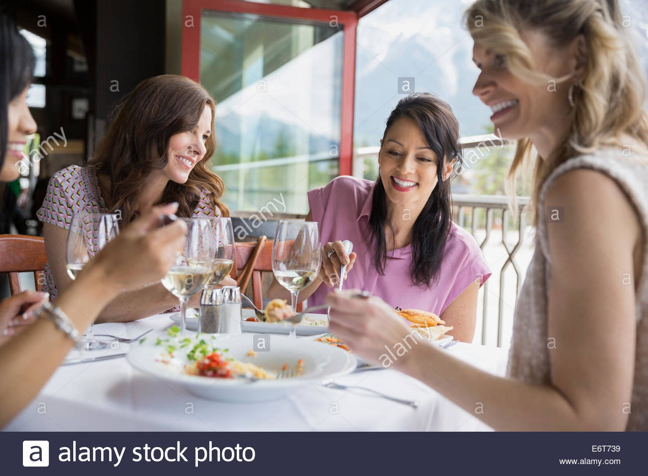 Women eating together in restaurant Stock Photo - Alamy