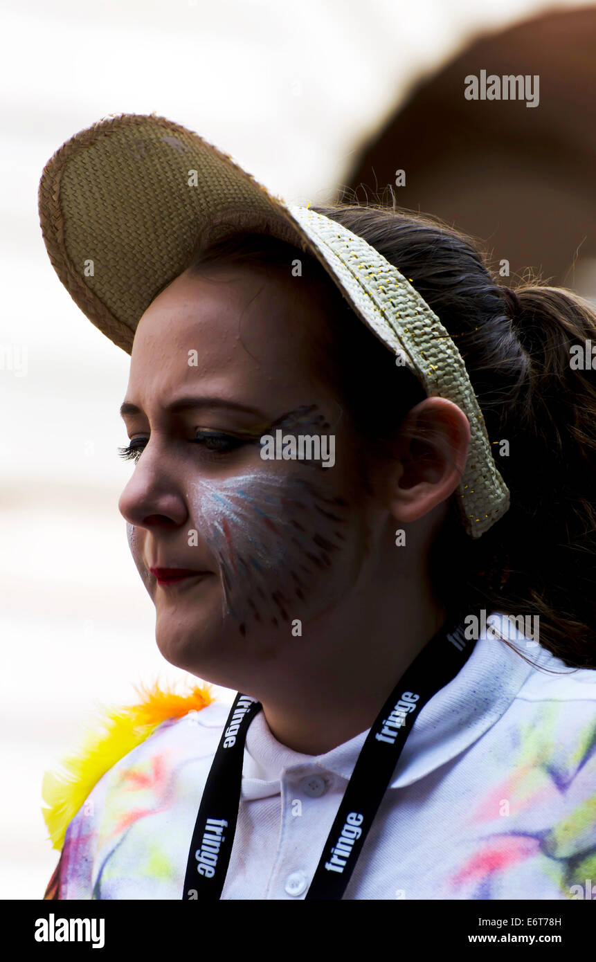 Woman with strange make-up and sun-shade promoting a show at the annual ...
