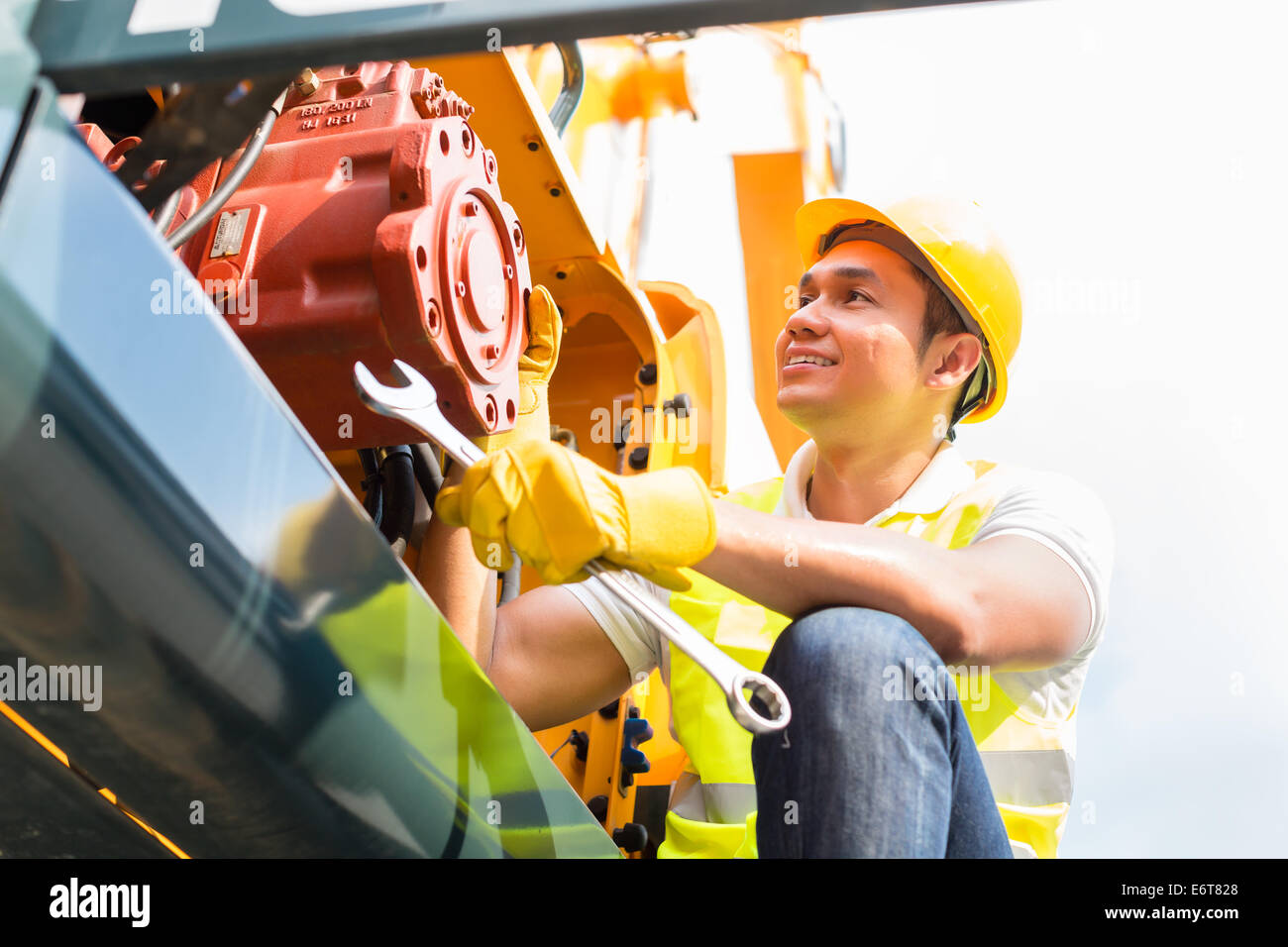 Asian engine mechanic engineer doing maintenance on machine Stock Photo ...