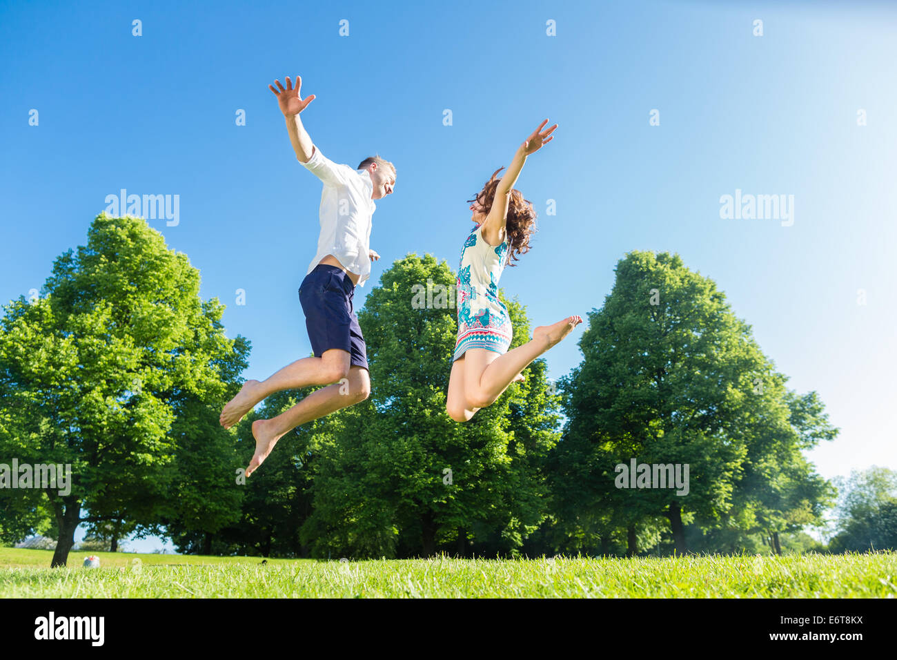 Woman jumping in park hi-res stock photography and images - Alamy