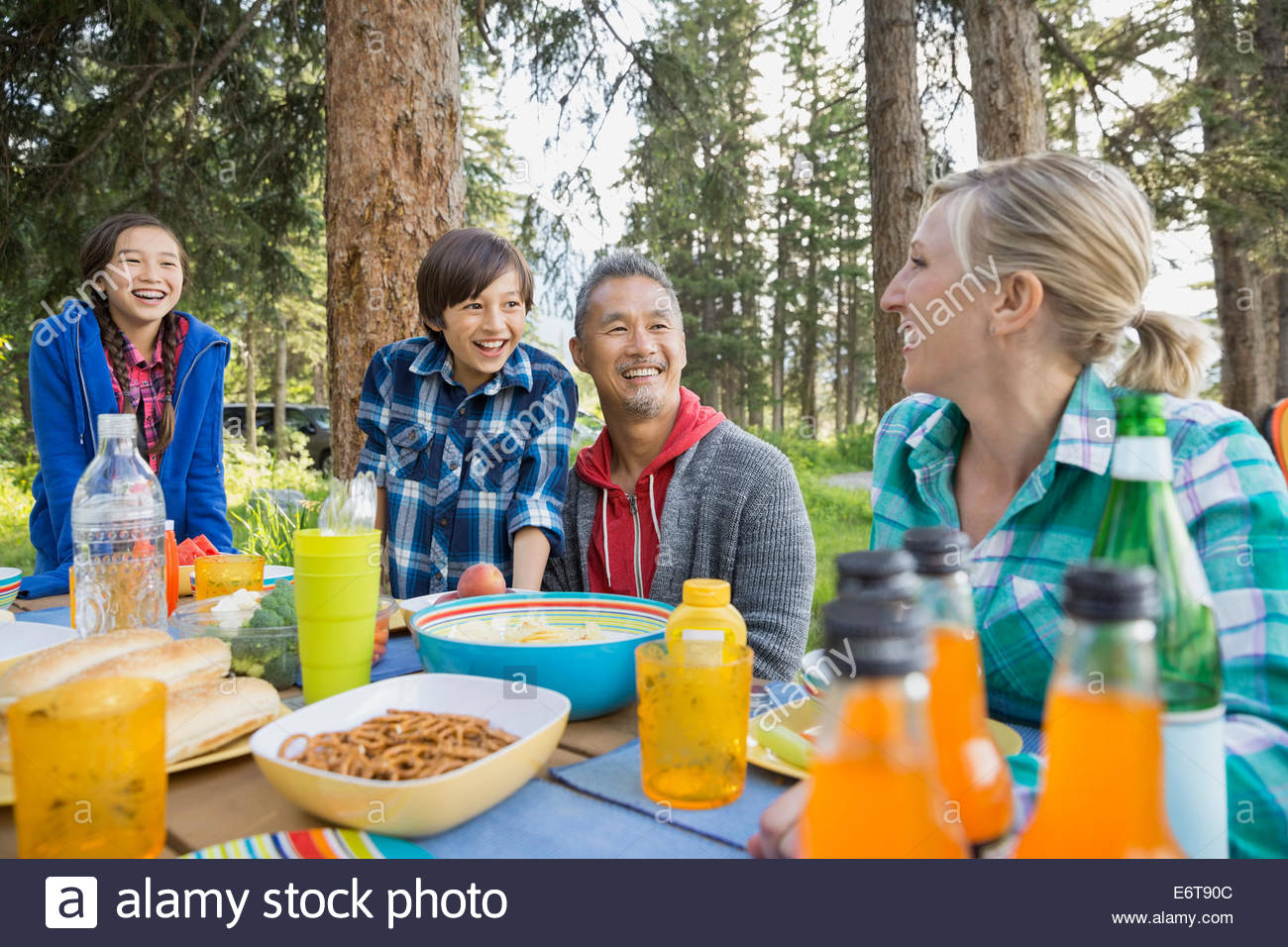 Family eating together at campsite Stock Photo - Alamy