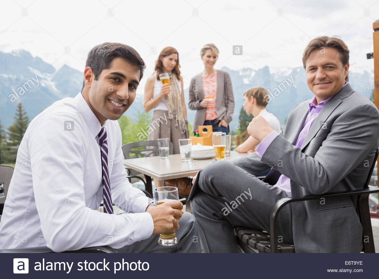 Businessmen smiling at networking event Stock Photo - Alamy