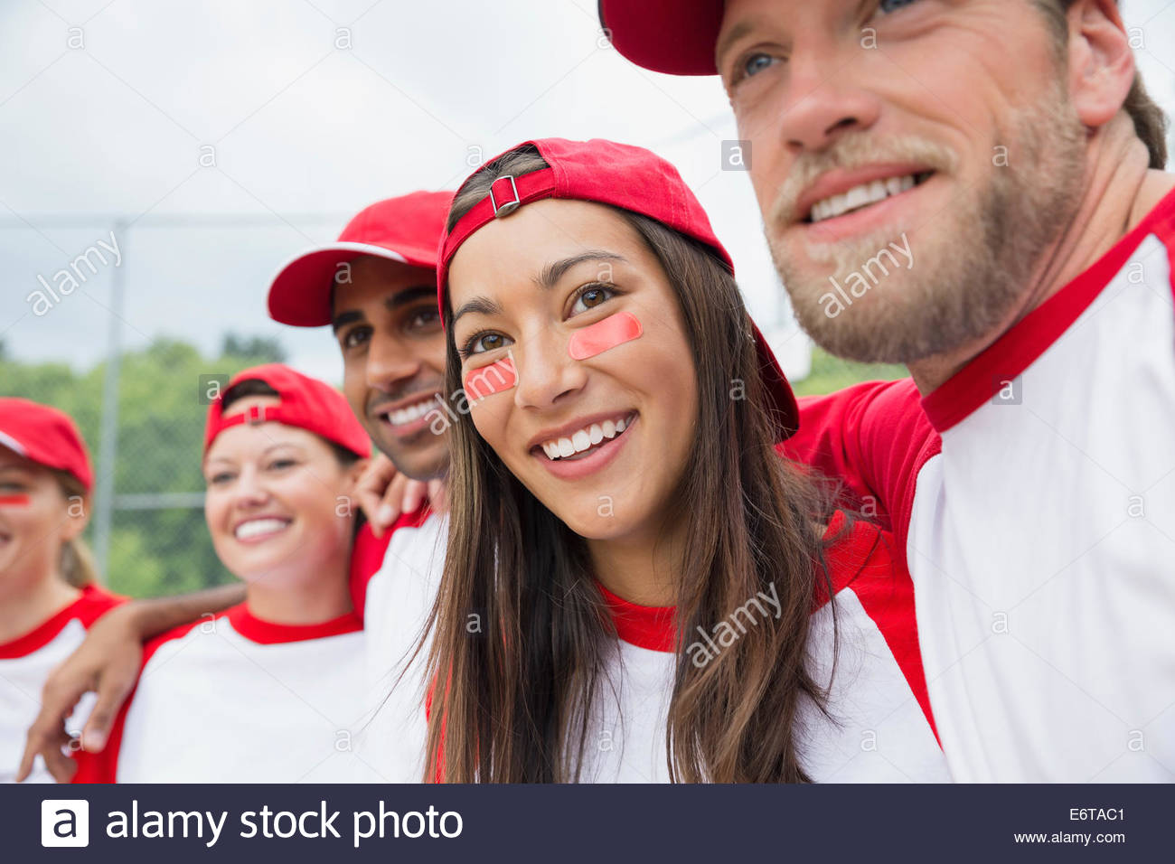 Baseball team laughing together in field Stock Photo - Alamy