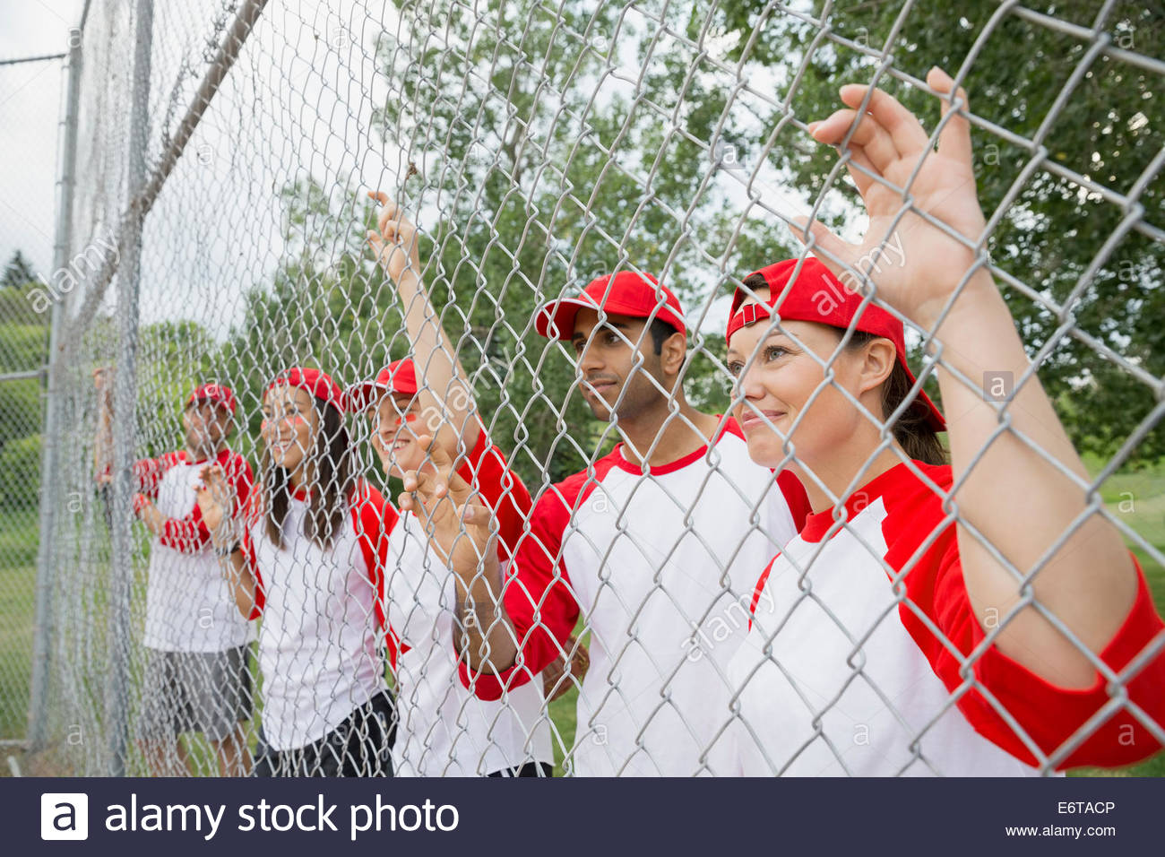 Group of people standing behind fence hi-res stock photography and ...