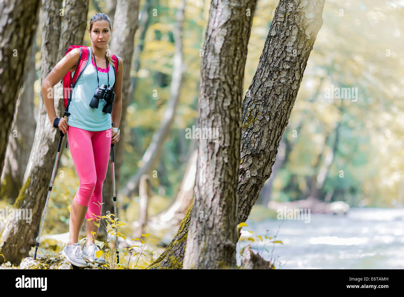 Young woman hiking in the forest Stock Photo - Alamy