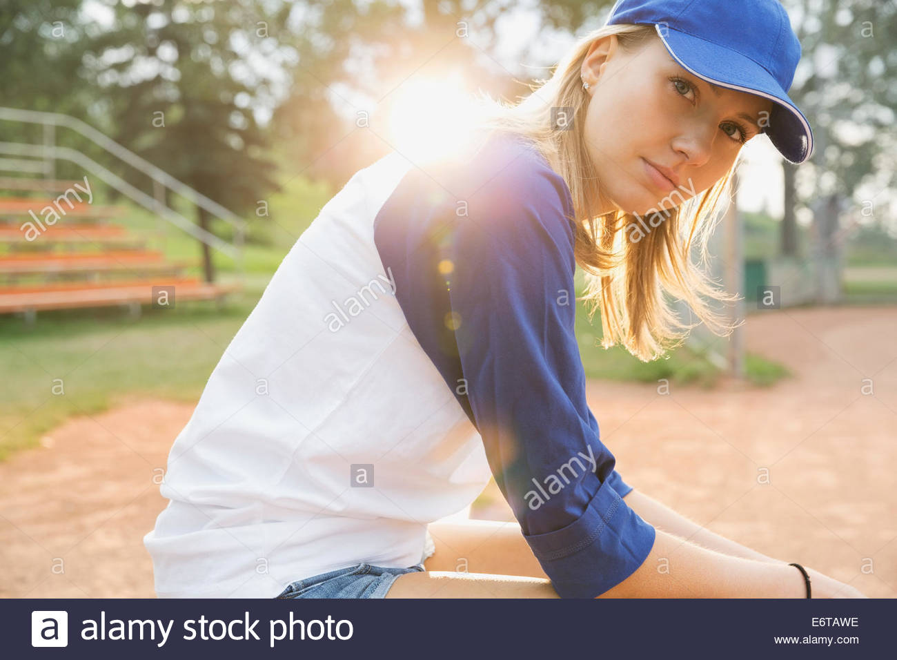 Baseball player sitting on field Stock Photo - Alamy