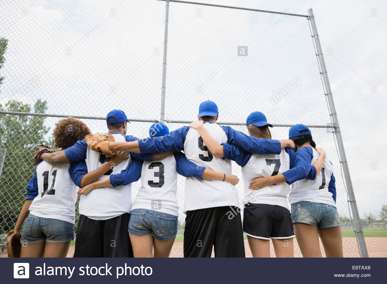 Baseball team standing together behind chain link fence Stock Photo - Alamy