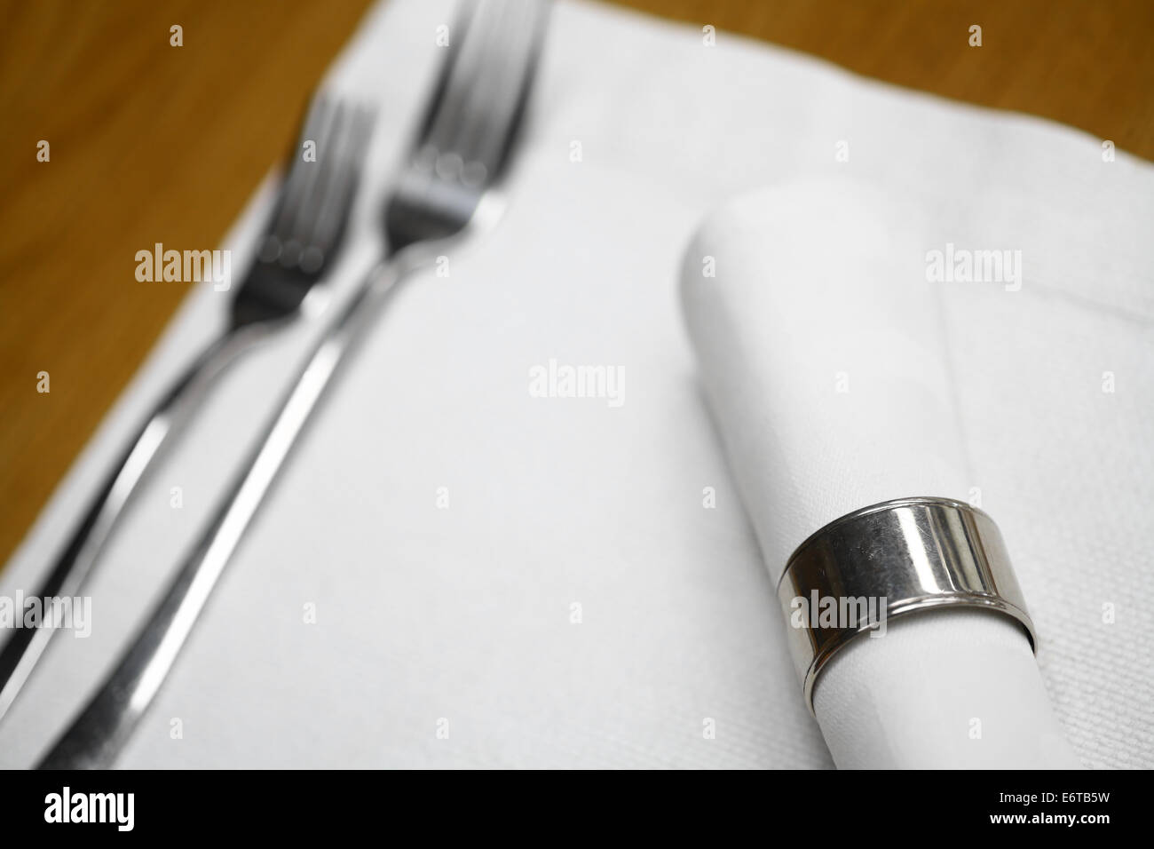 Two forks on a dinner table in a restaurant Stock Photo - Alamy