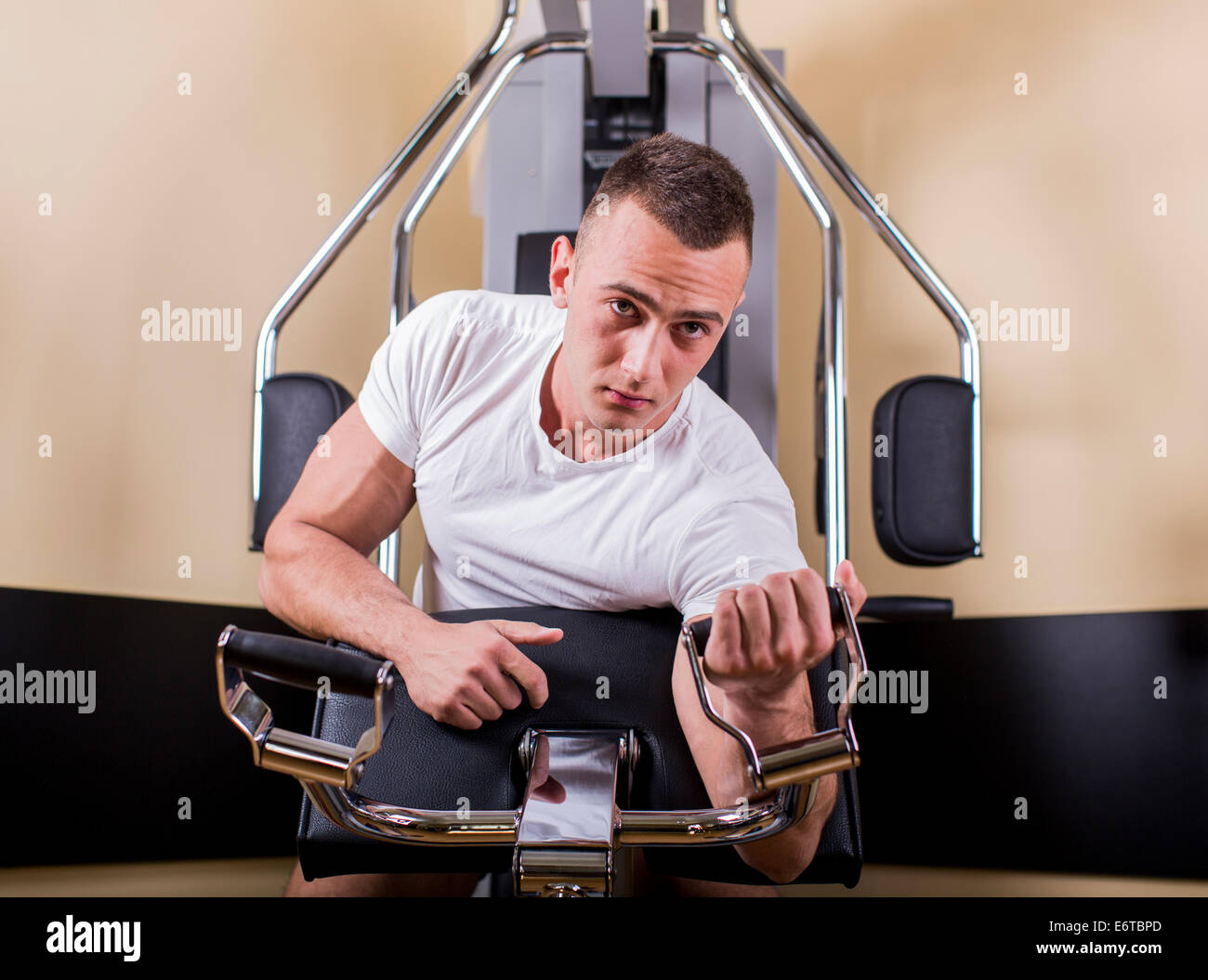 Attractive young man training in the gym Stock Photo - Alamy