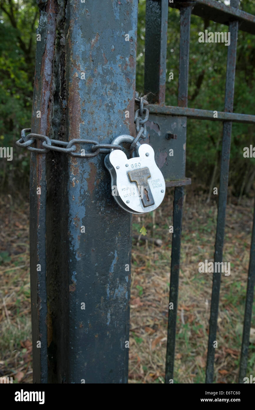 New padlock on a rusty fence Stock Photo - Alamy