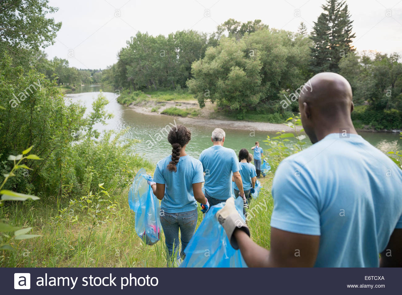Man carrying garbage bags hi-res stock photography and images - Alamy