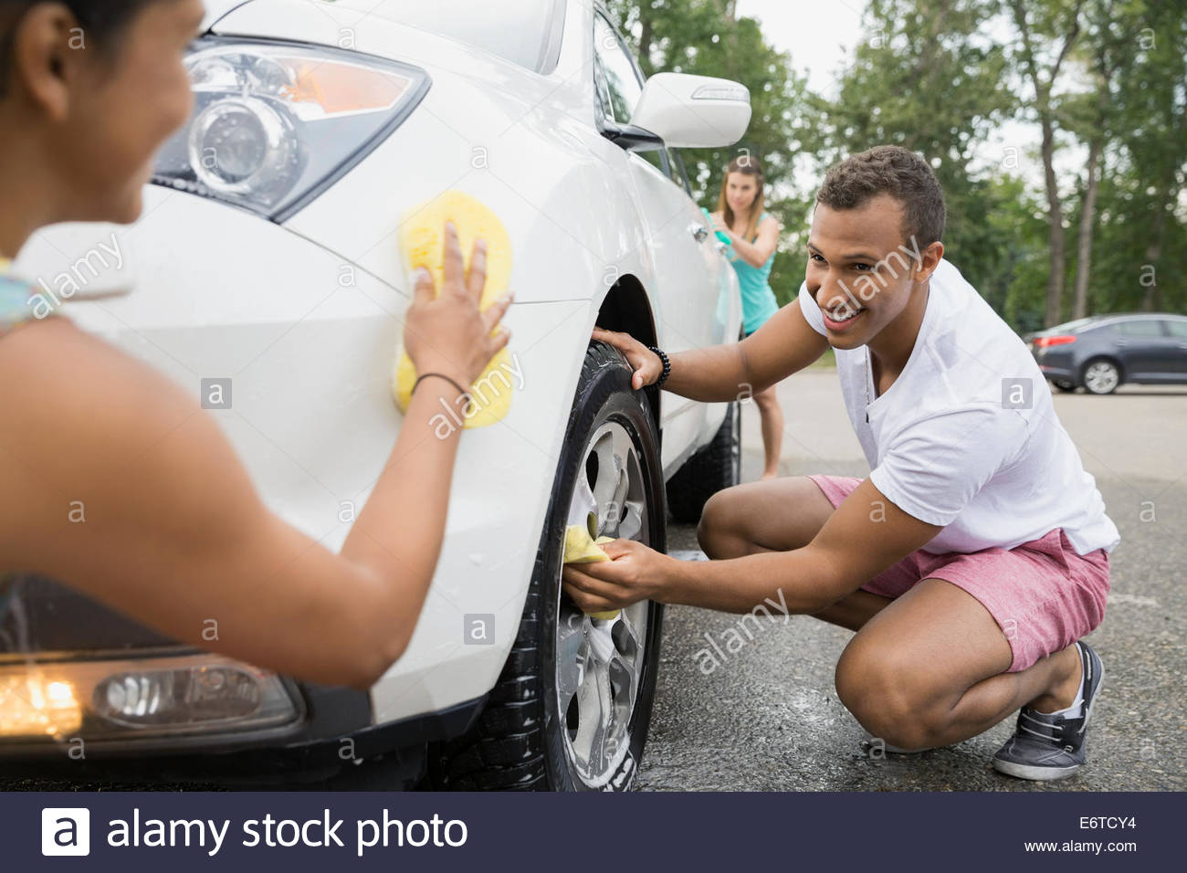 Friends washing car Stock Photo - Alamy