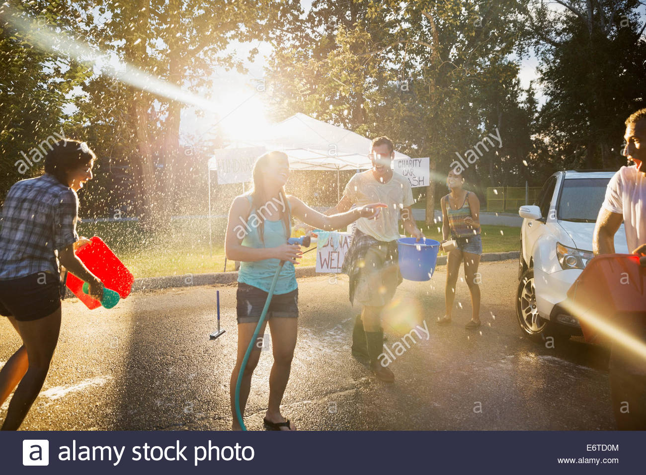 Woman playing water hose hi-res stock photography and images - Alamy
