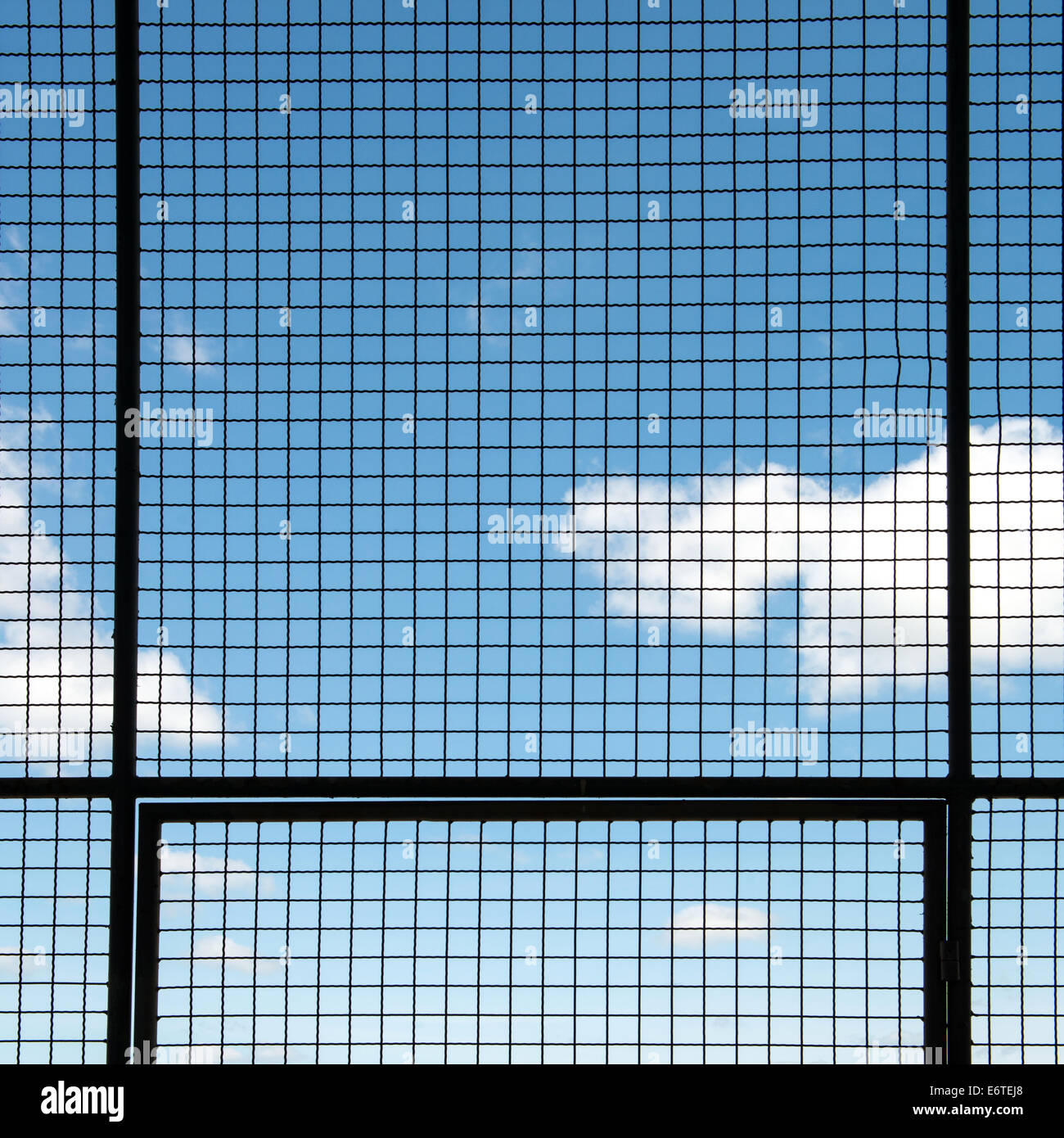 Metal mesh wire fence with blue sky and cloud background Stock Photo ...
