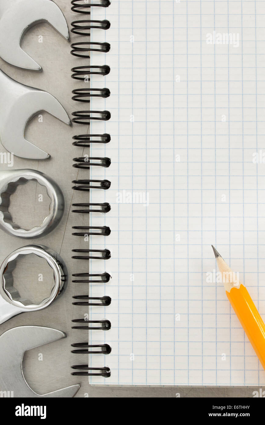wrench tools and notebook at metal background Stock Photo - Alamy