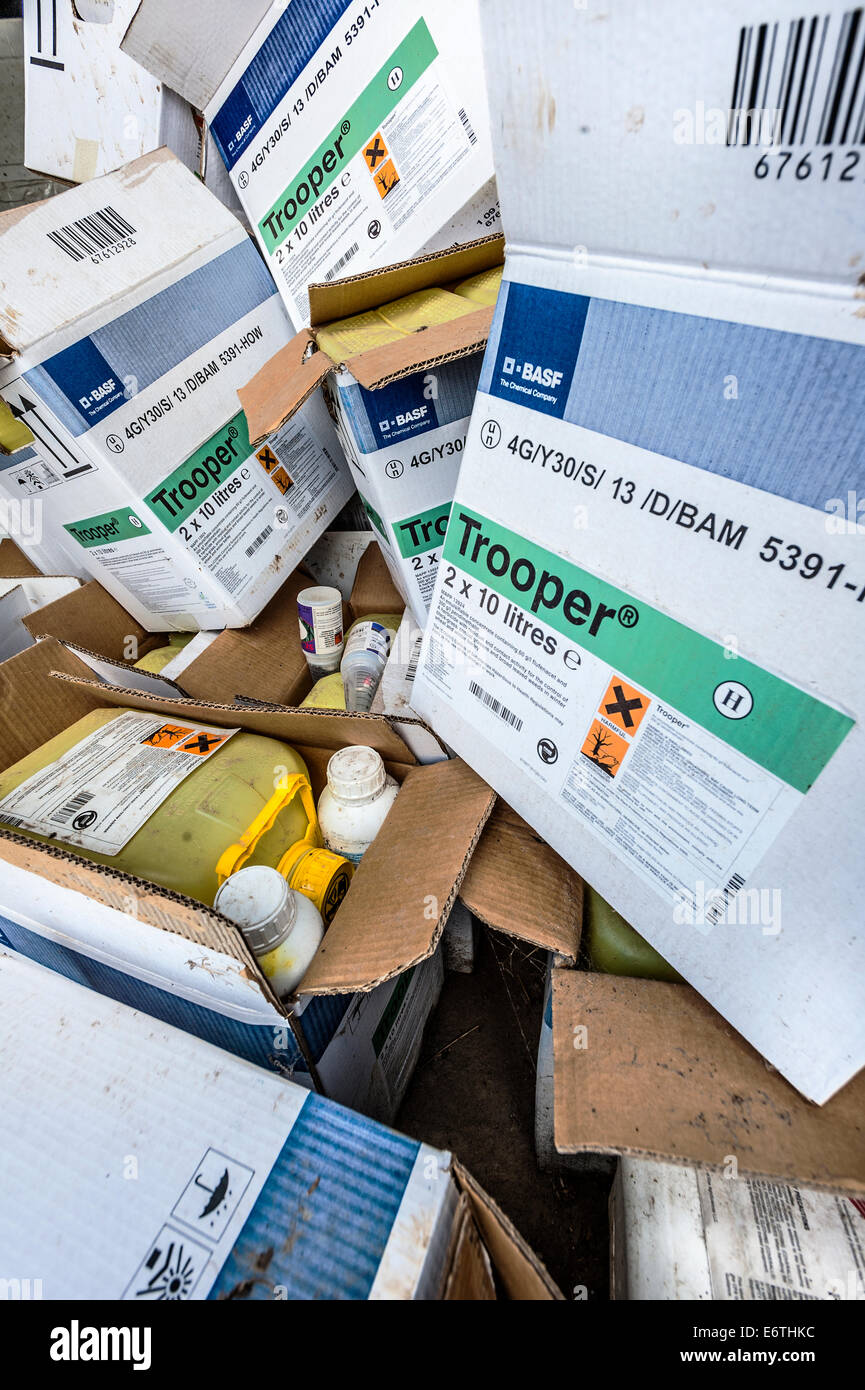 A pile of empty pesticide boxes containers and cans piled up in the ...