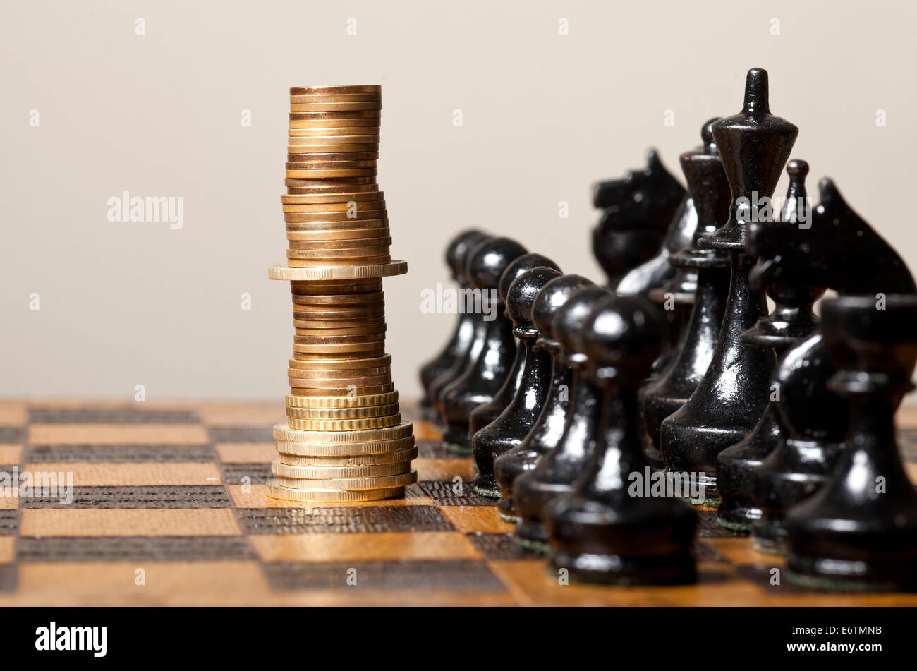 Euro coins stacked like a king on a chess board Stock Photo - Alamy