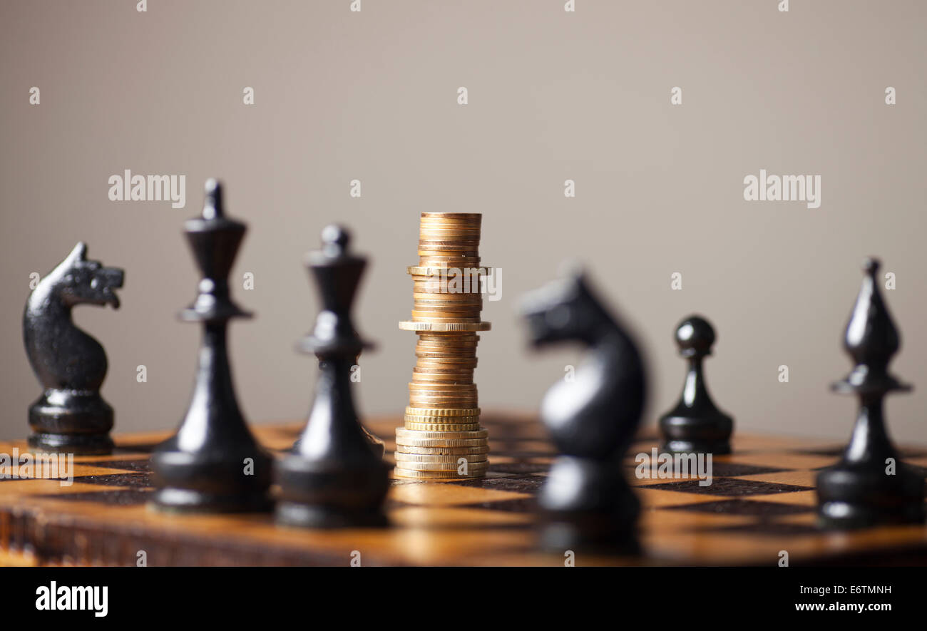 Euro coins stacked like a king on a chess board Stock Photo - Alamy