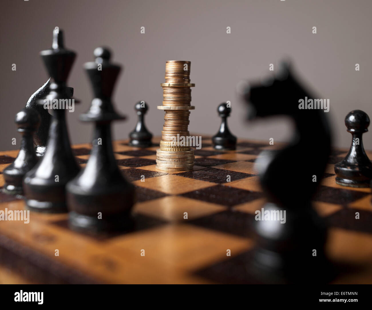 Euro coins stacked like a king on a chess board Stock Photo - Alamy