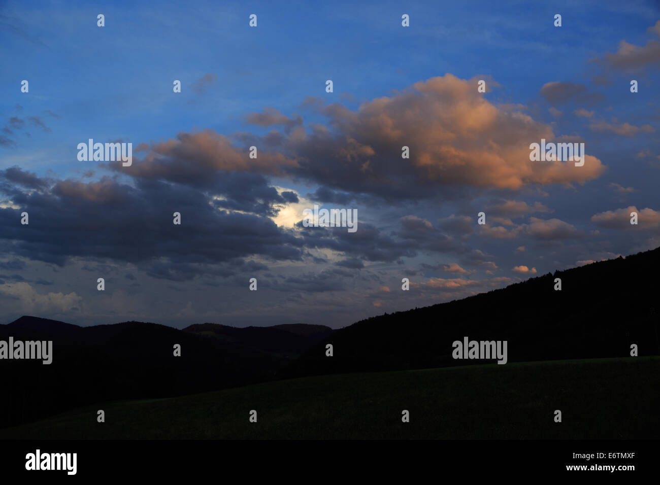 A photograph of the moon showing in the distance between some dark and ...