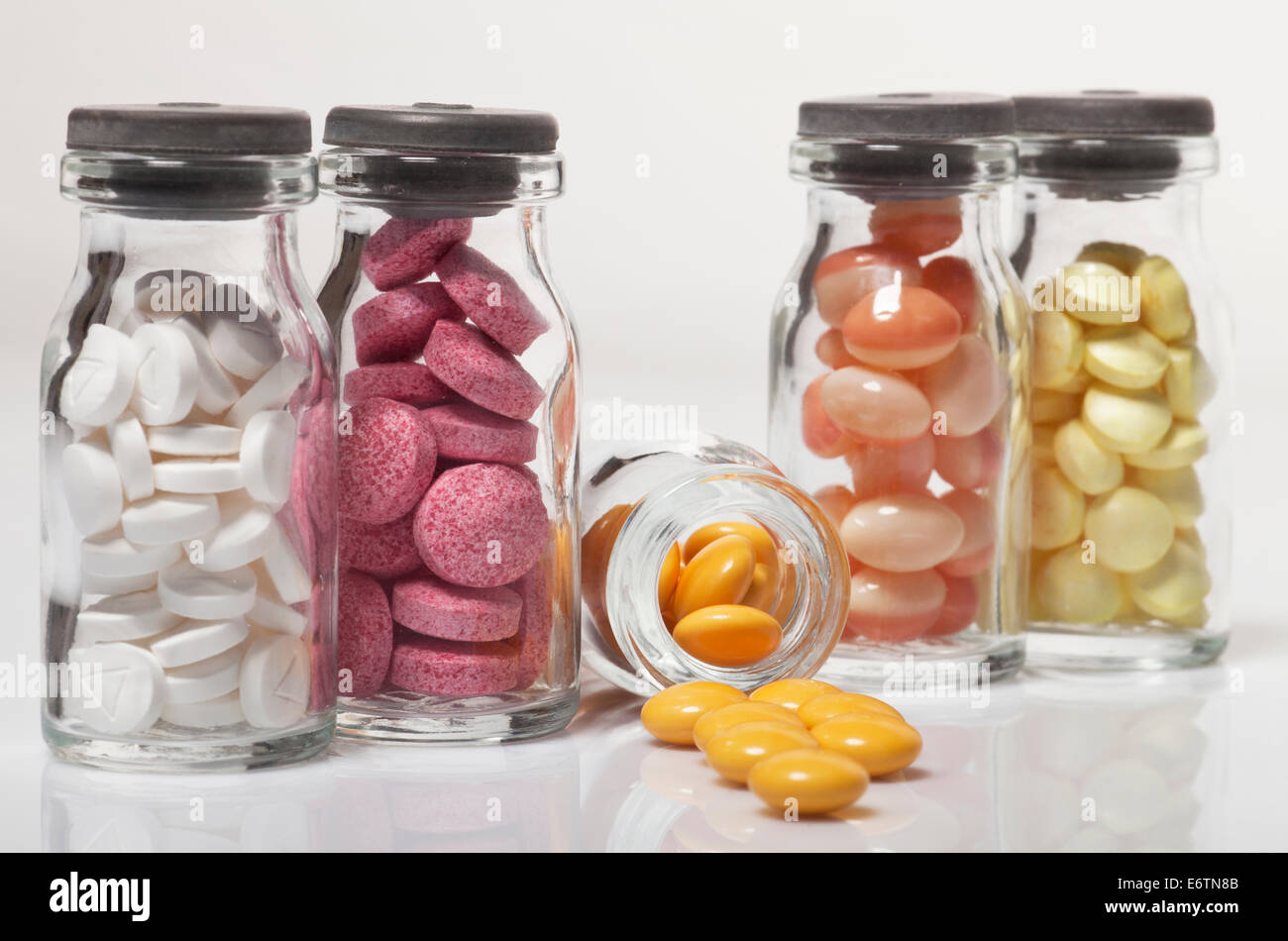 Pills in different colors in glass medicine vials. Macro Stock Photo ...